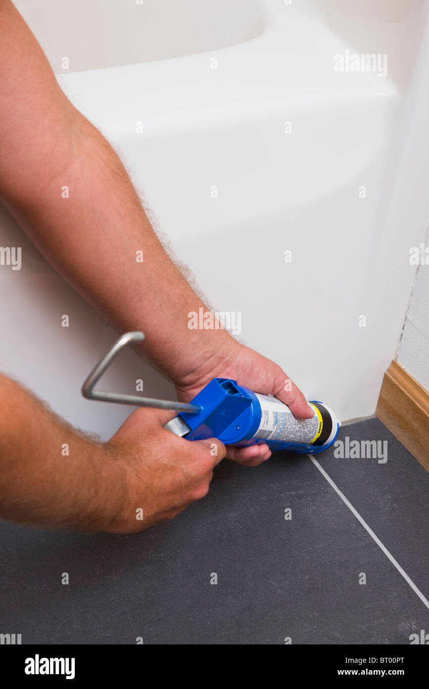 Man using caulking gun, close-up Stock Photo - Alamy