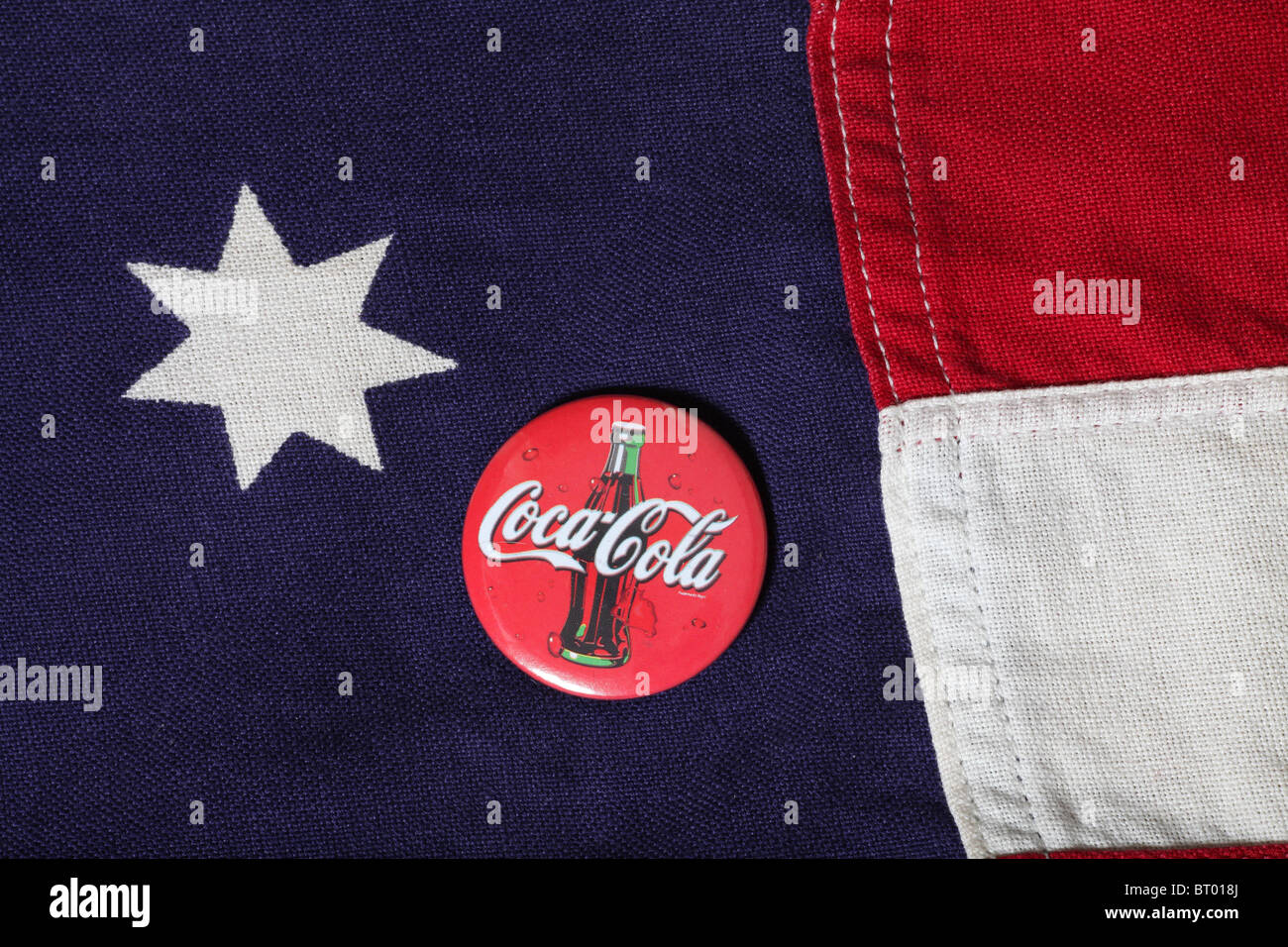 A Coca-Cola badge pinned to an American flag Stock Photo - Alamy