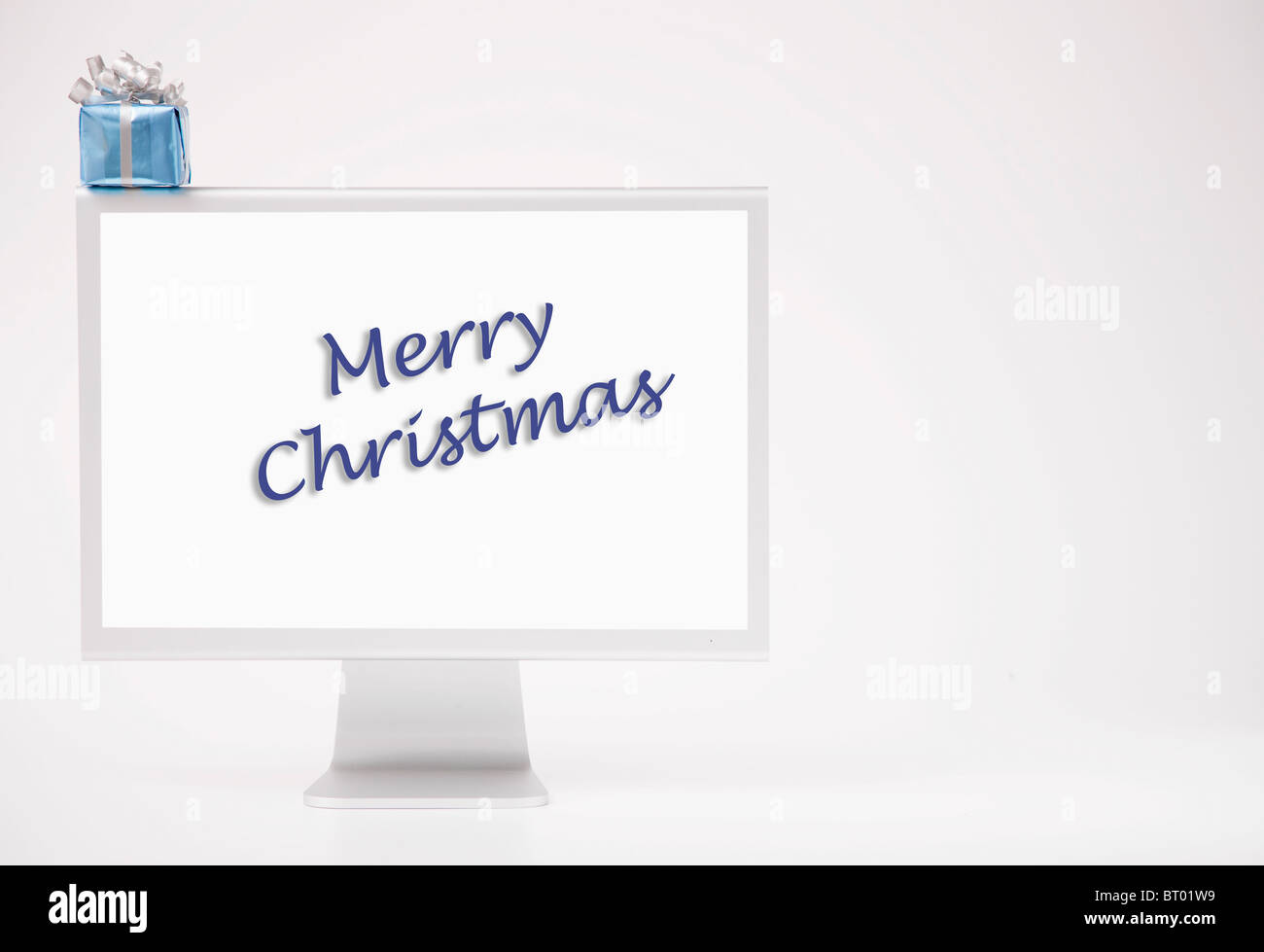 Computer monitor displaying merry Christmas phrase Stock Photo - Alamy