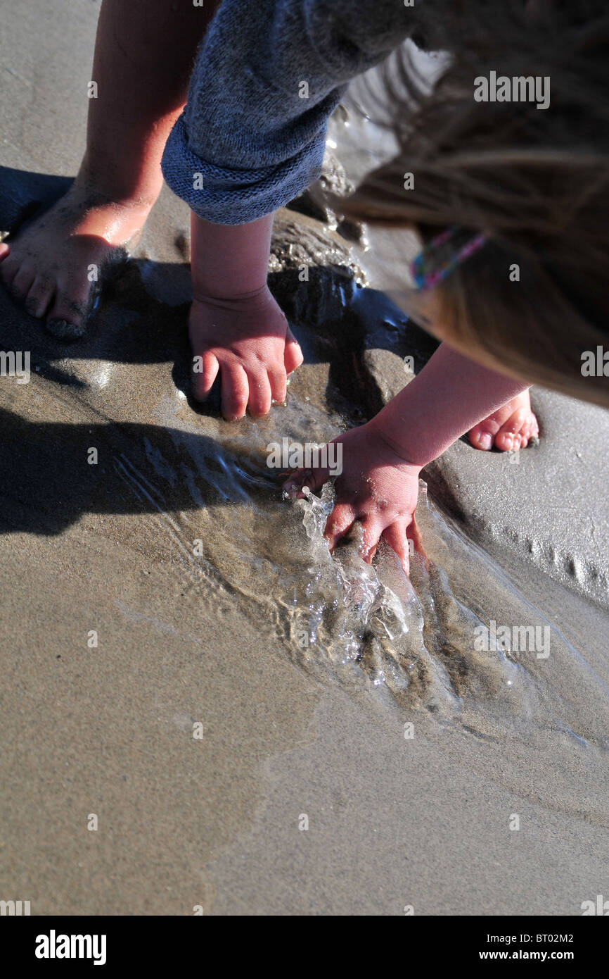 LITTLE GIRL PLAYING IN THE WATER AND SAND, SOMME (80), PICARDY, FRANCE ...