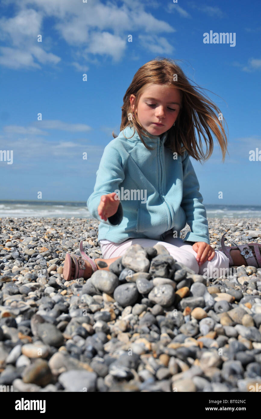 LITTLE GIRL PLAYING WITH PEBBLES, SOMME (80), PICARDY, FRANCE Stock ...