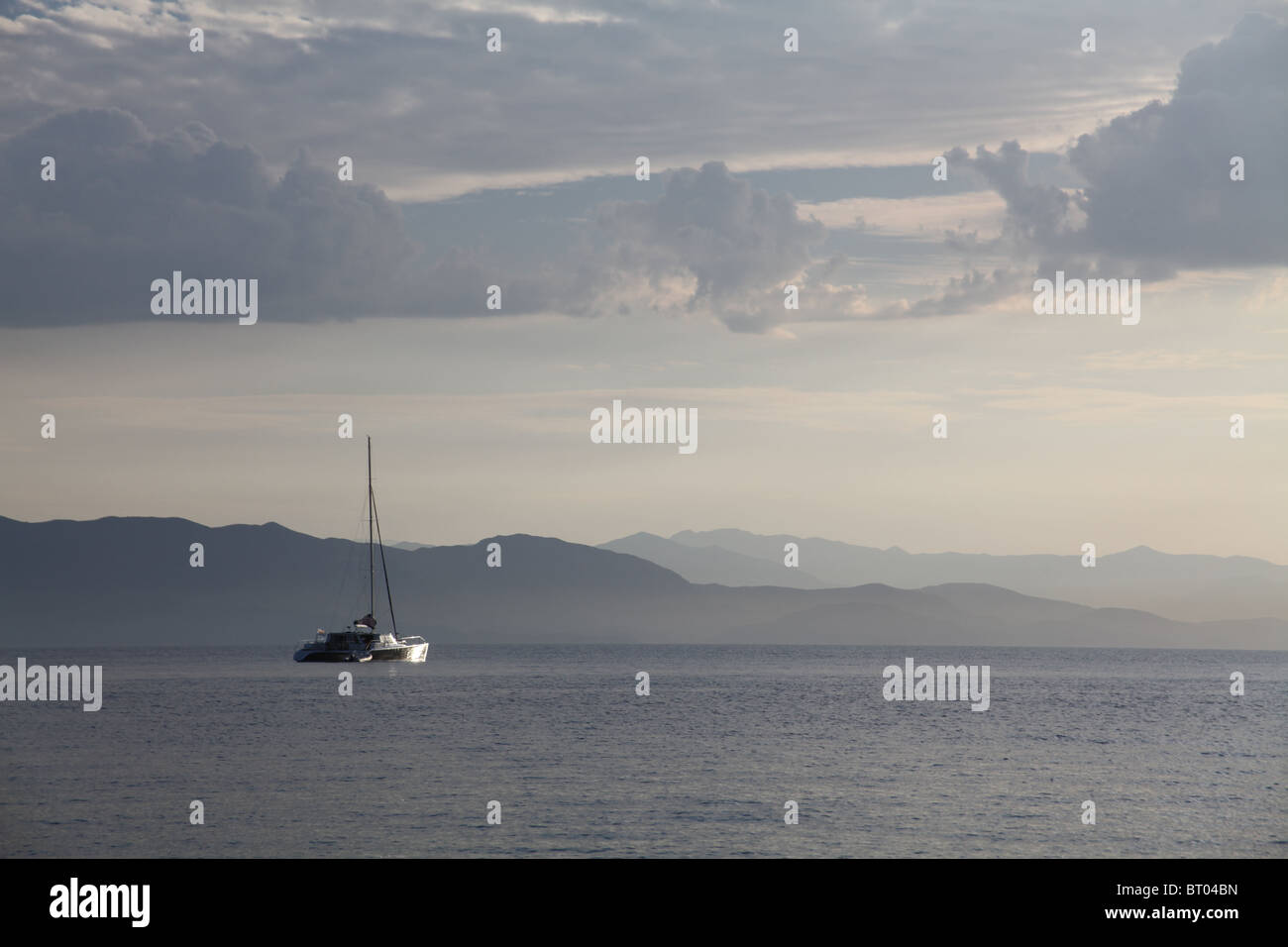 Boat sailing into sunrise with dramatic sky Stock Photo - Alamy
