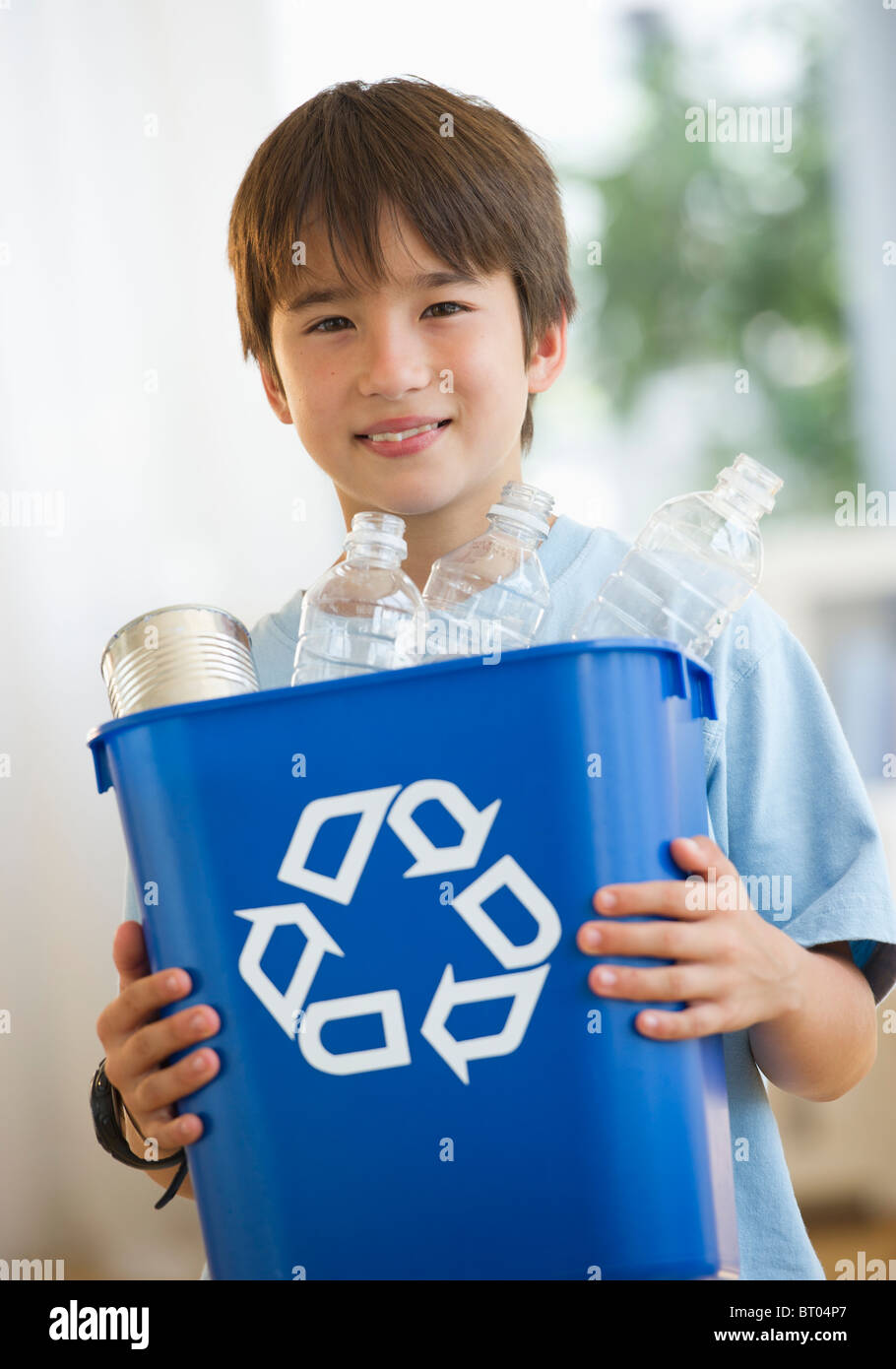 Boy carrying recycling bin hi-res stock photography and images - Alamy