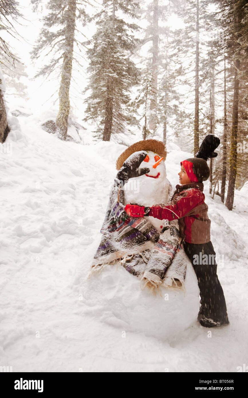 Girl hugging snowman Stock Photo - Alamy