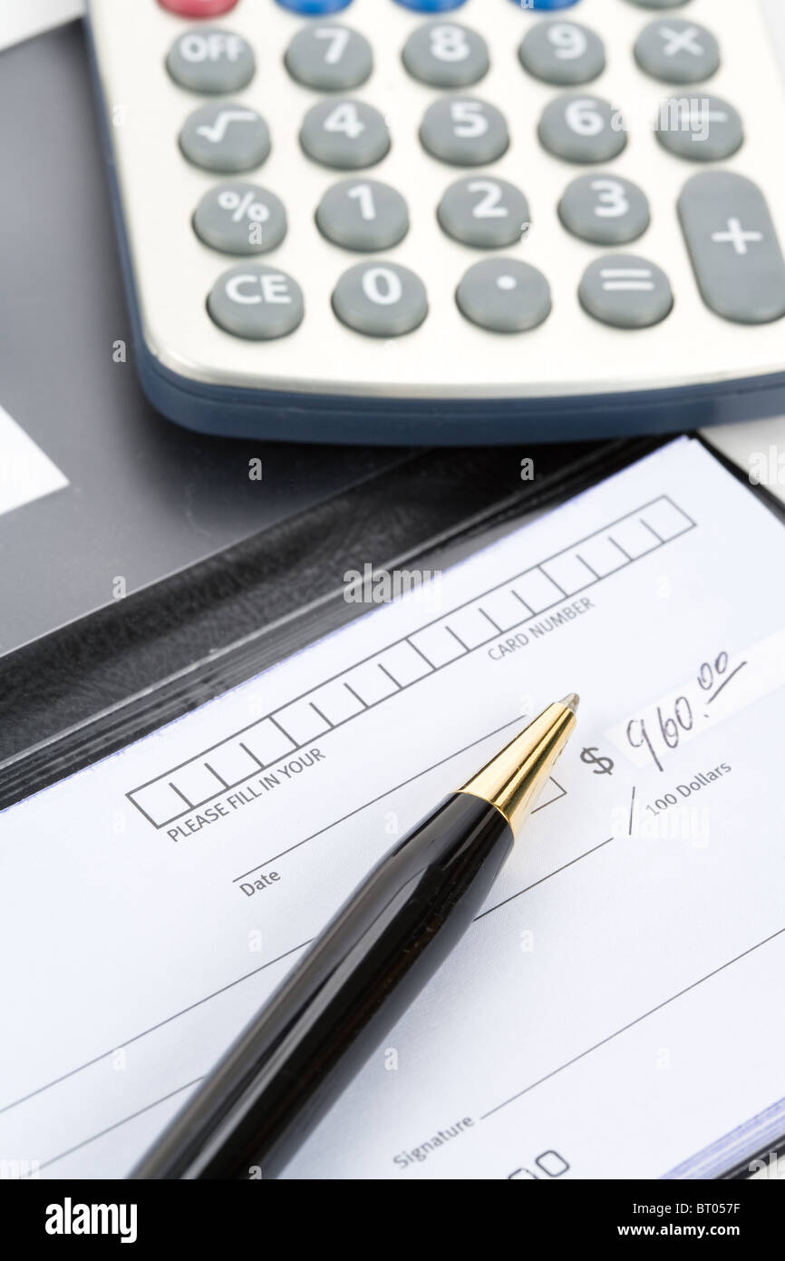Checkbook and pen close up Stock Photo - Alamy