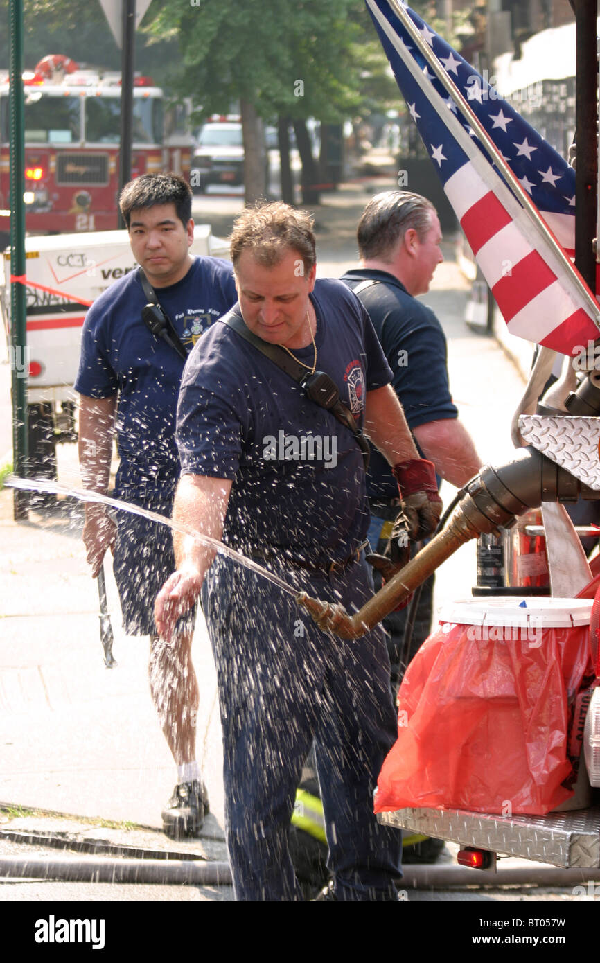 New York Firefighter at the scene of a fire in Manhattan Stock Photo ...