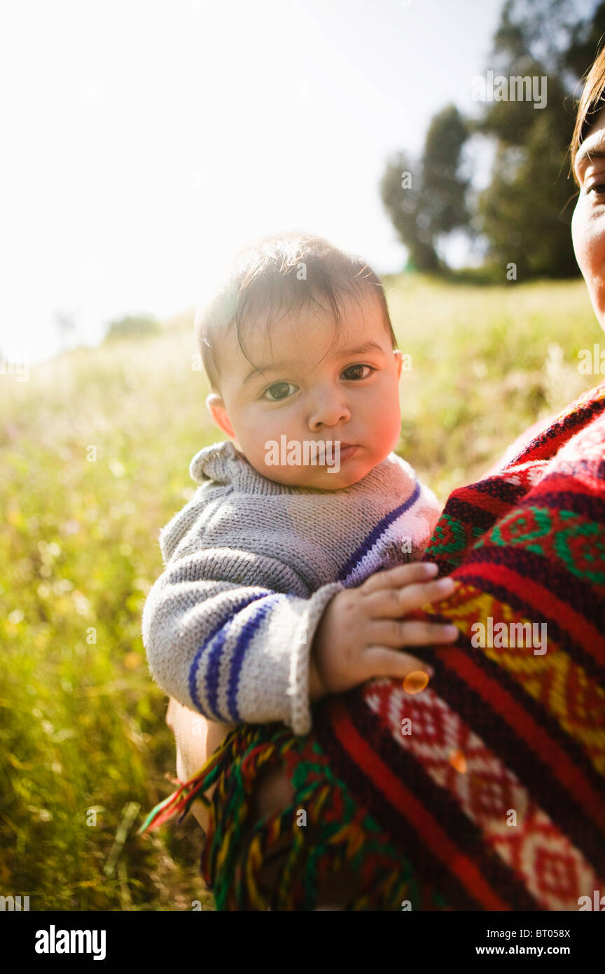Mother holding baby in field Stock Photo - Alamy