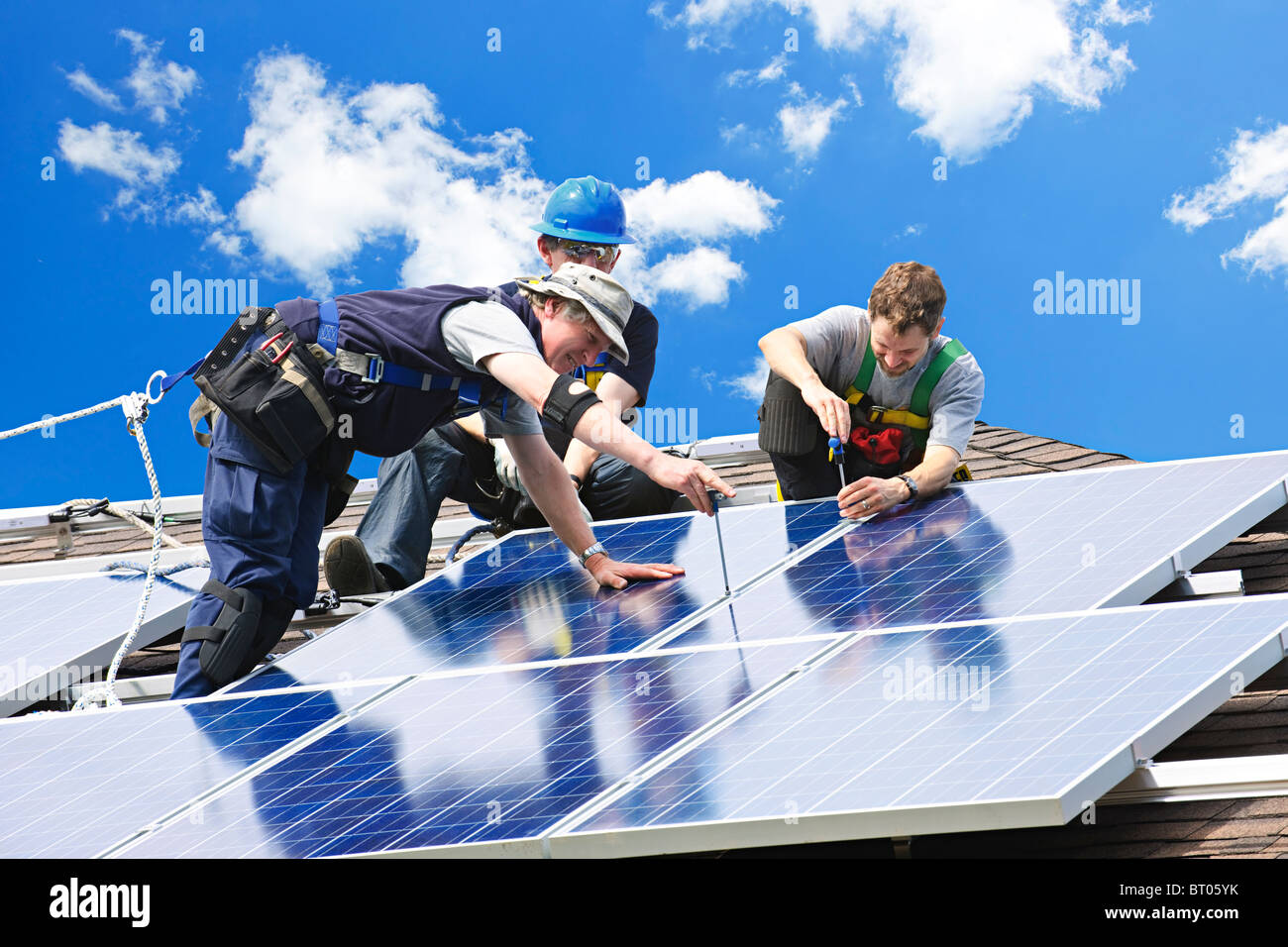 Three workers install solar panel hi-res stock photography and images ...