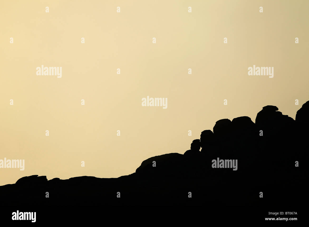 A silhouette of Haytor at sunset on Dartmoor National Park in Devon ...