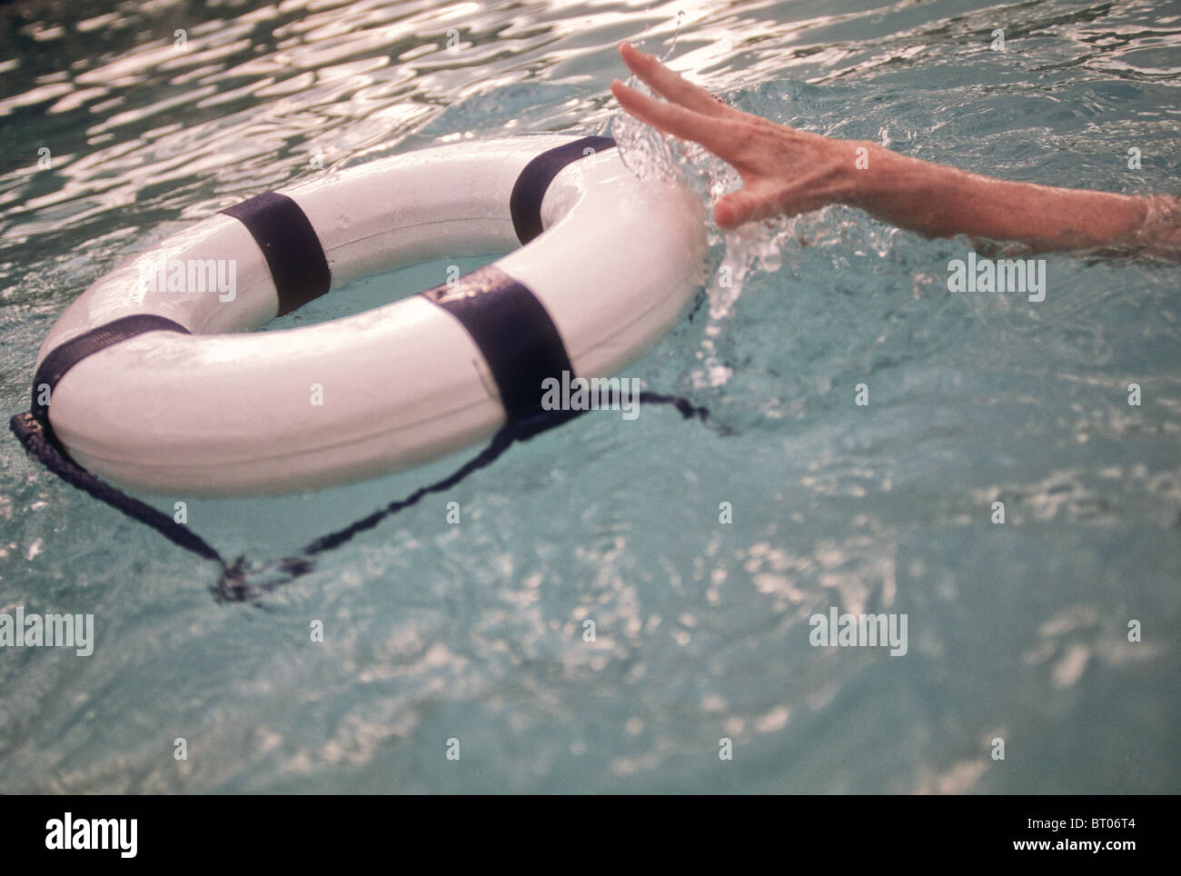 hand reaching for life preserver Stock Photo - Alamy