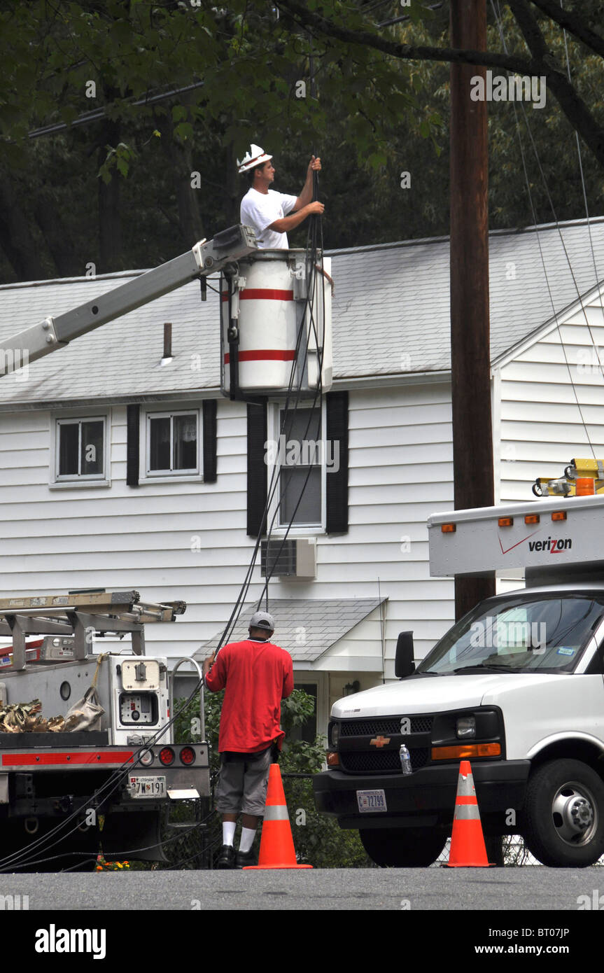 Utility workers work on installing fiber optic cable in Greenbelt ...