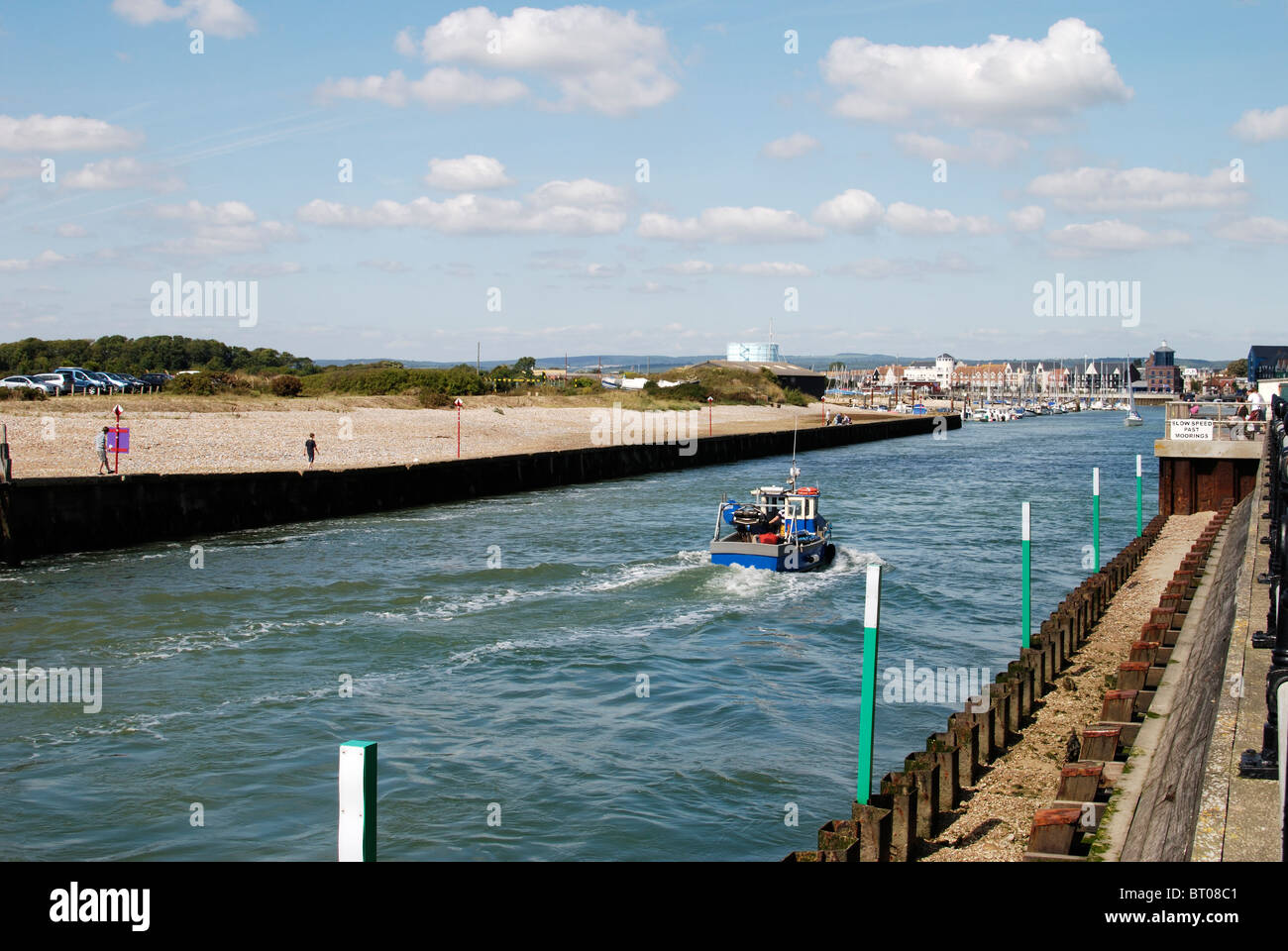 Fishing boat returning on The River Arun on an incoming tide at ...