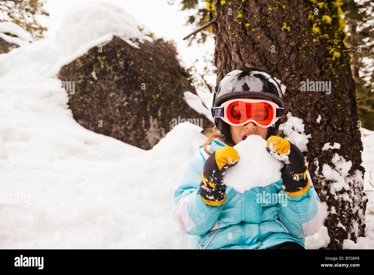 Girl eating snow Stock Photo - Alamy