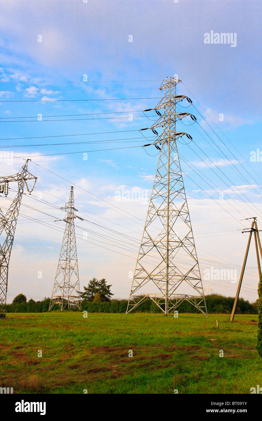 High voltage pylons under blue sky Stock Photo - Alamy