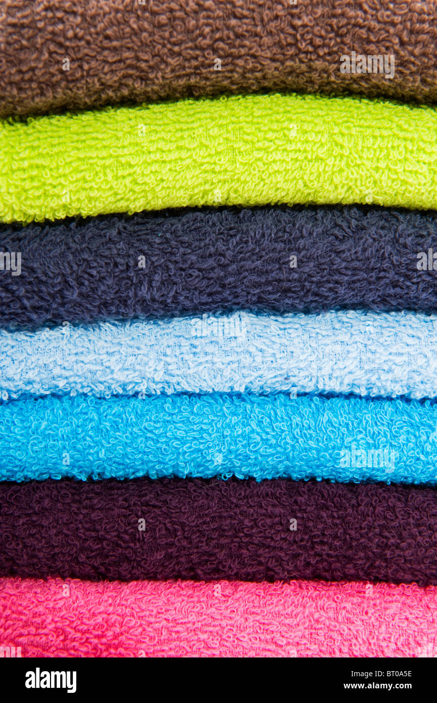Many Folded and stacked colorful terry towels Stock Photo - Alamy