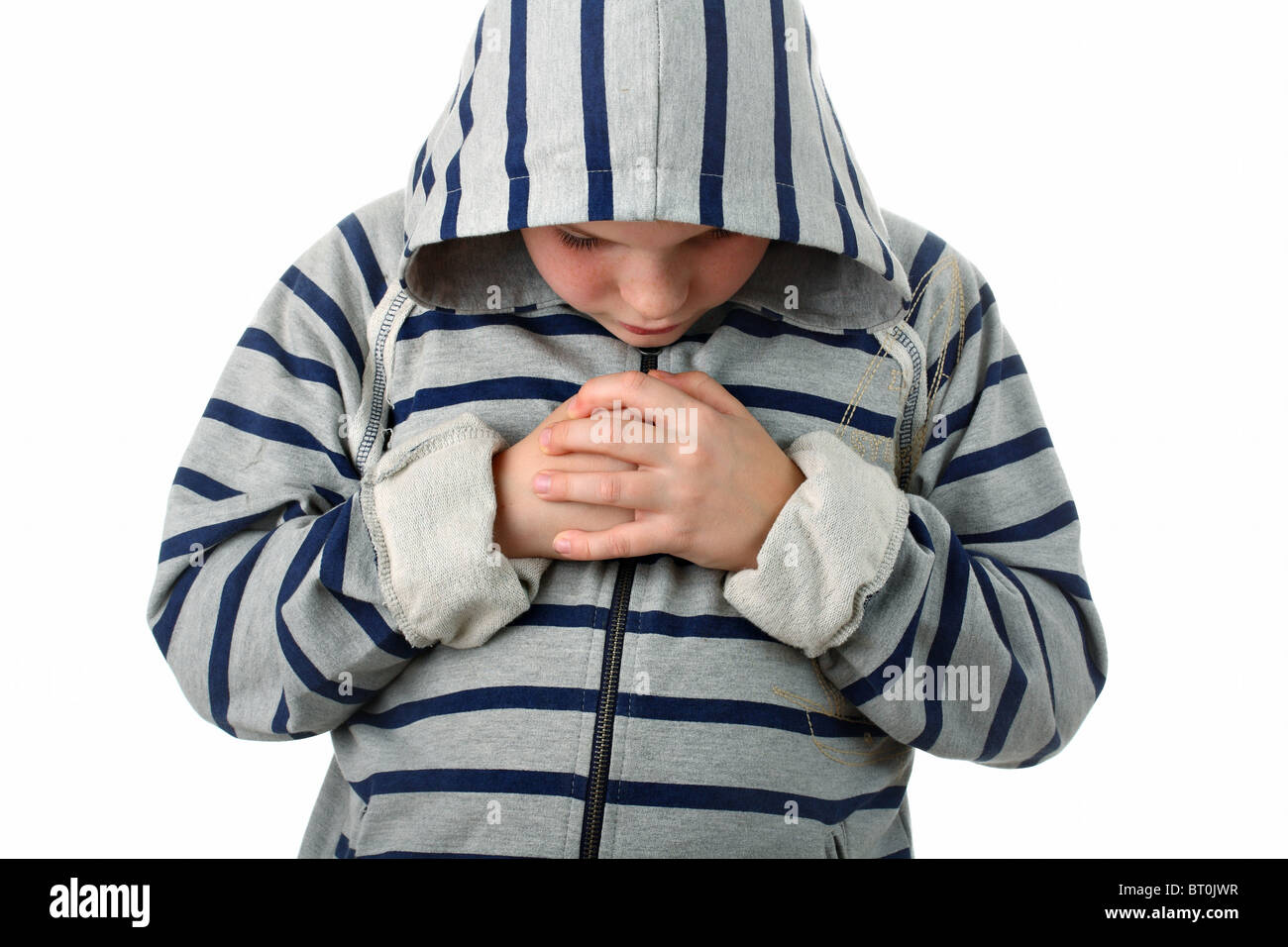 Small boy praying before the sports match isolated on white Stock Photo ...