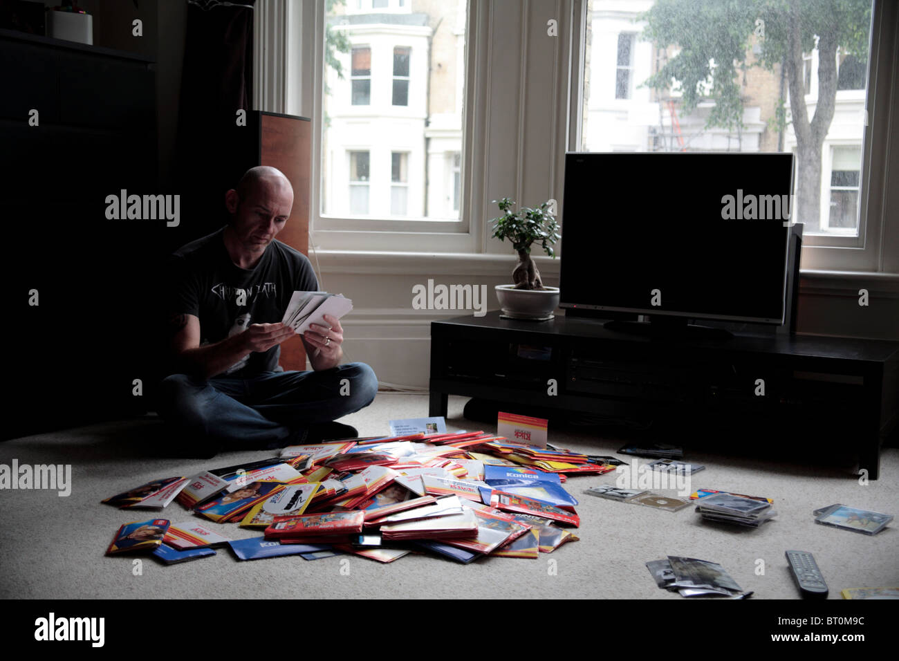 man looking at photos Stock Photo - Alamy