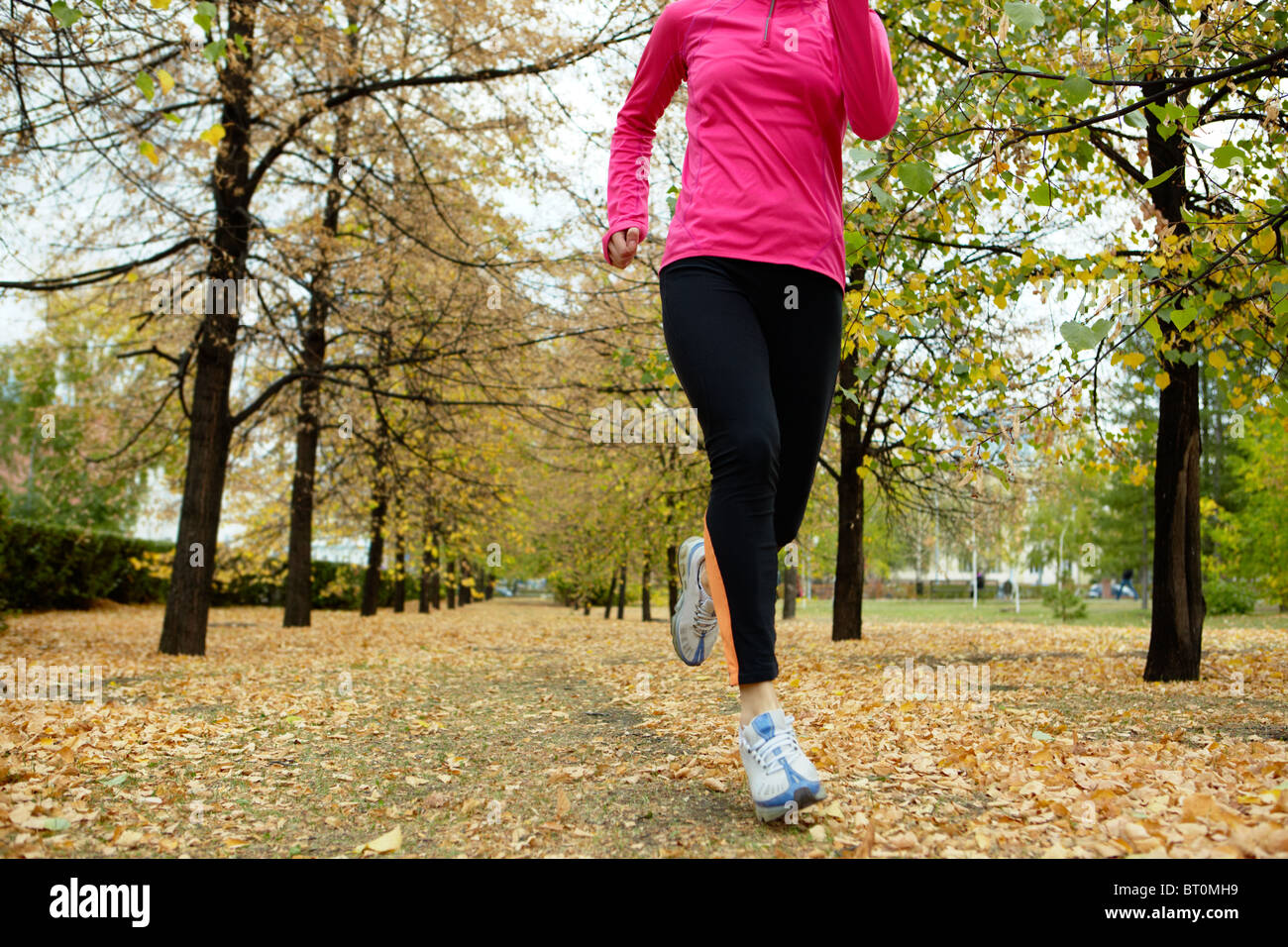 Girl running among autumn trees Stock Photo - Alamy