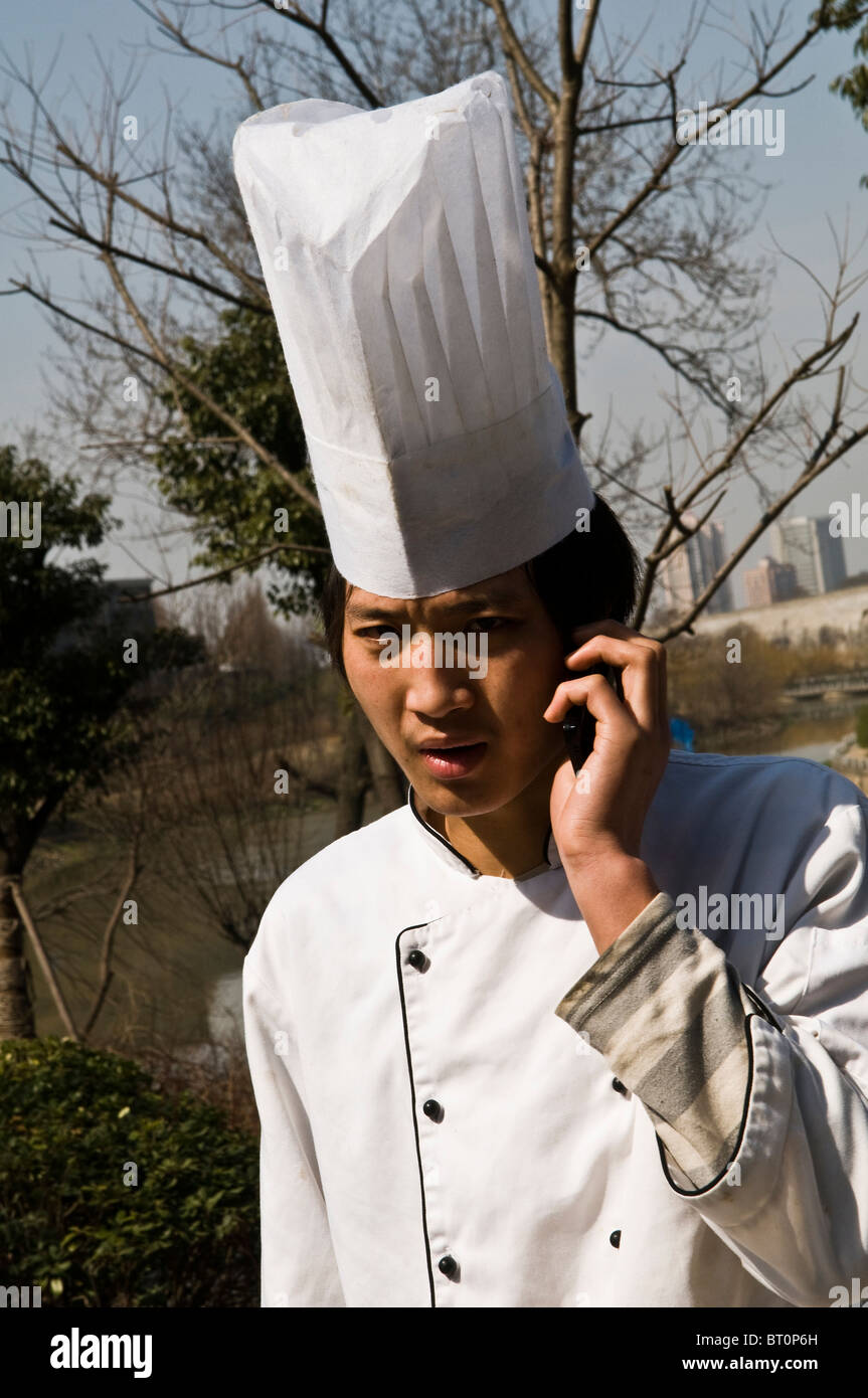 A Chinese chef talking on his mobile phone Stock Photo - Alamy
