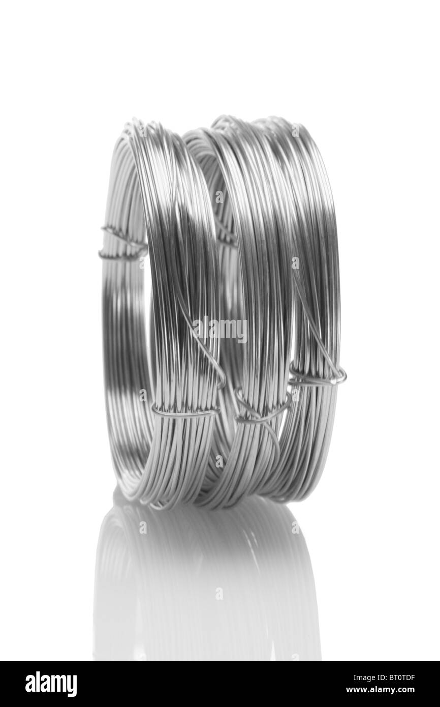 Coils of galvanized wires standing on white background Stock Photo - Alamy