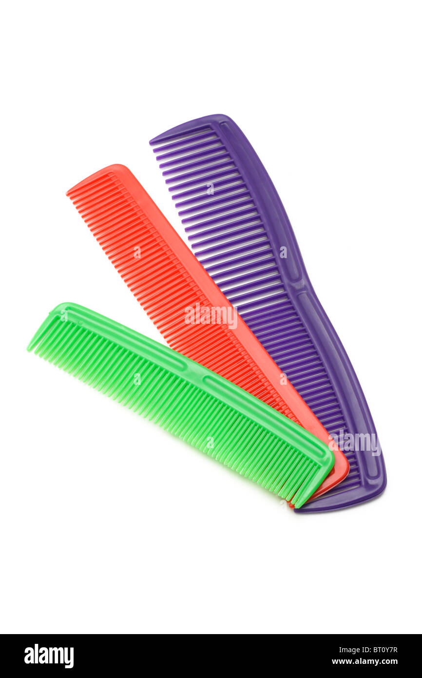 Three colorful plastic combs on white background Stock Photo - Alamy