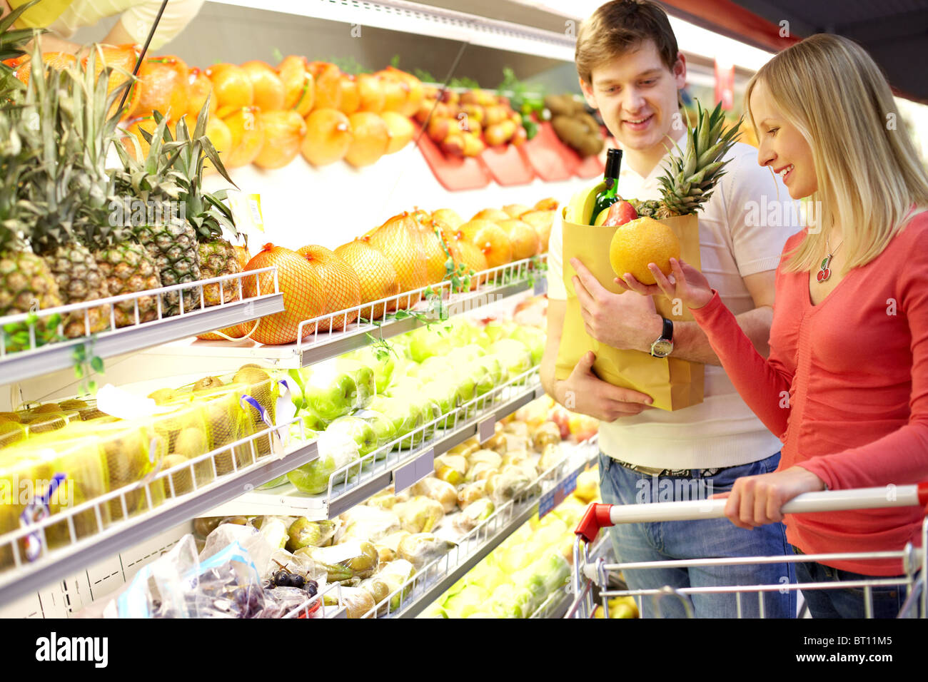 Portrait of couple choosing fruits in supermarket Stock Photo - Alamy