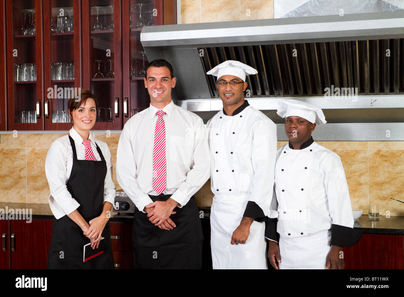 group of restaurant staff in commercial kitchen Stock Photo - Alamy