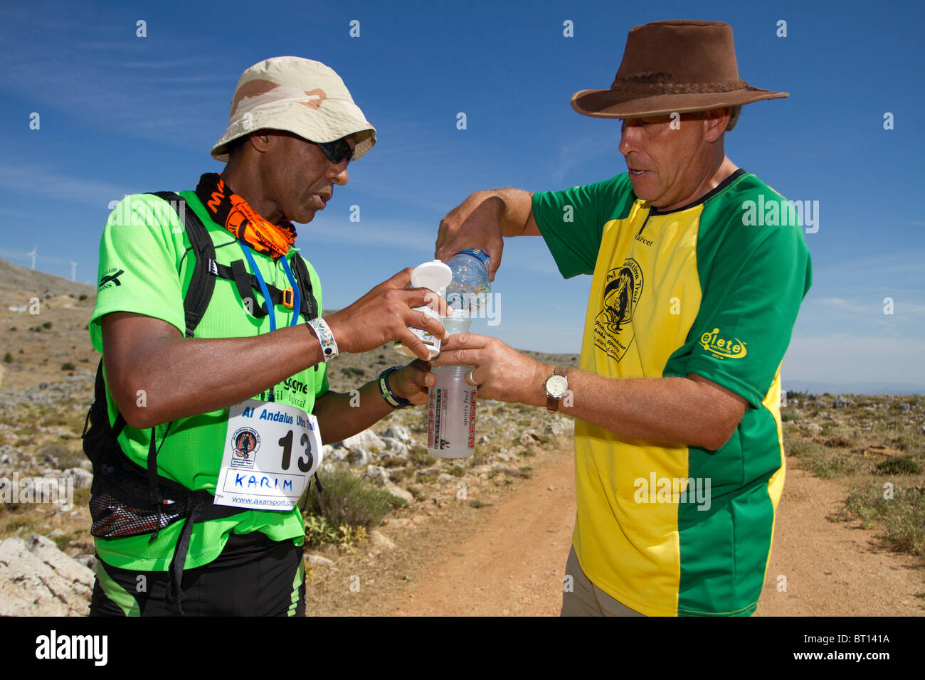 Moroccan extreme distance runner, Karim Mosta fills up with water at a ...