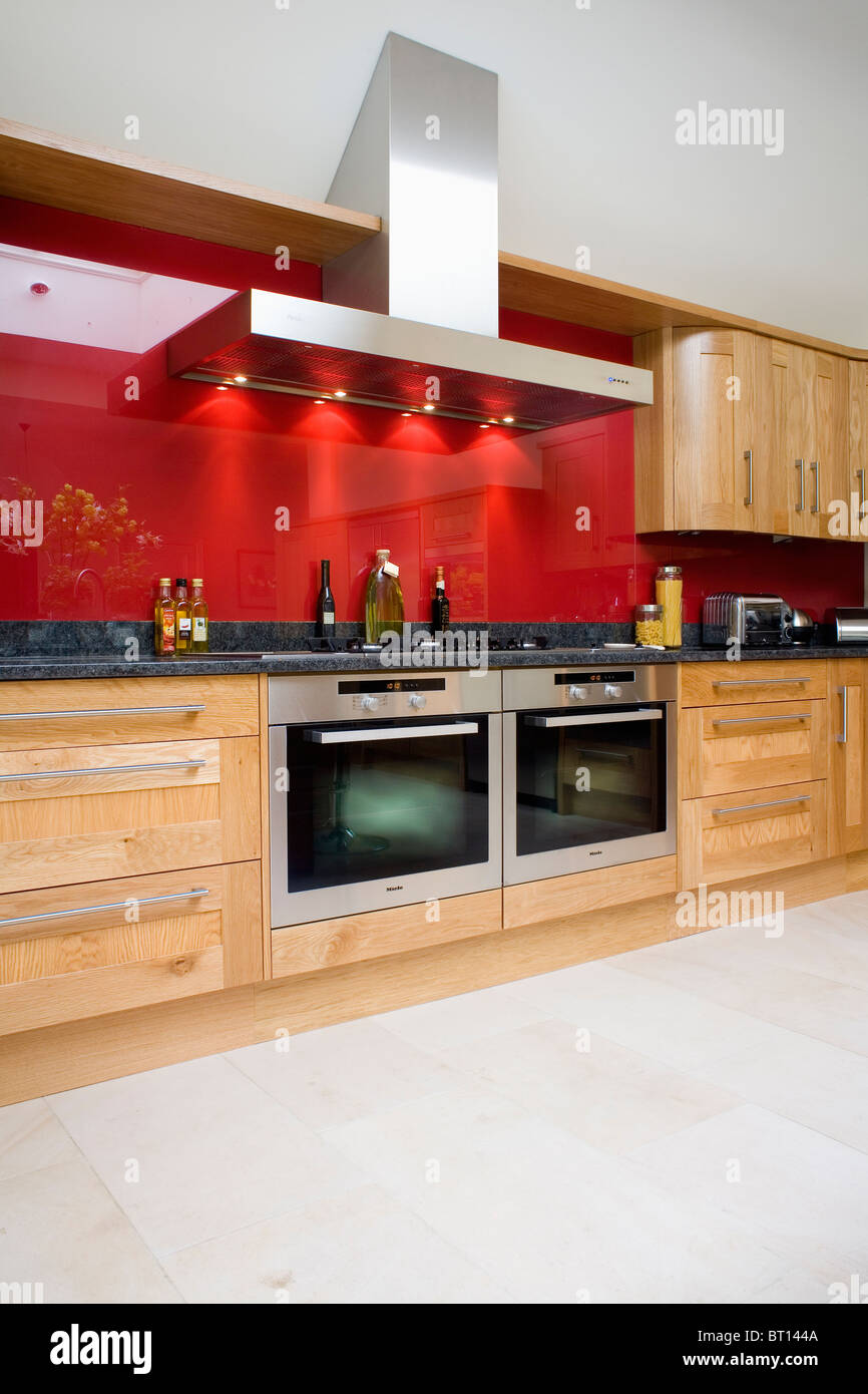 Large stainless-steel extractor with integral lighting above hob and ...
