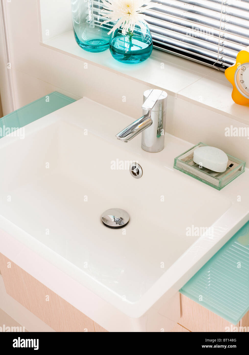 Close-up of stainless steel mixer tap and rectangular white basin in ...