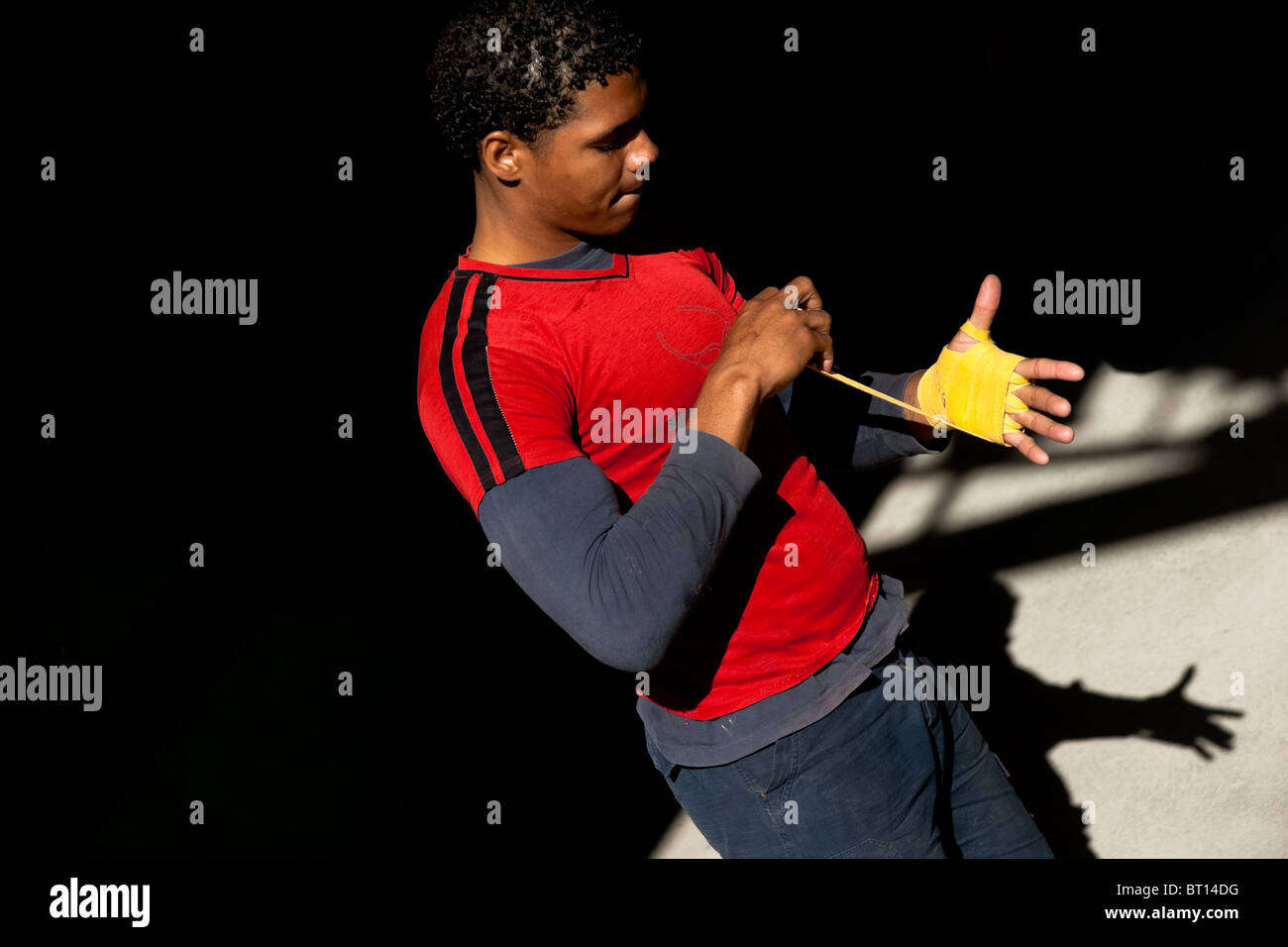 A Cuban boxer prepares bandage before a training session at Rafael ...