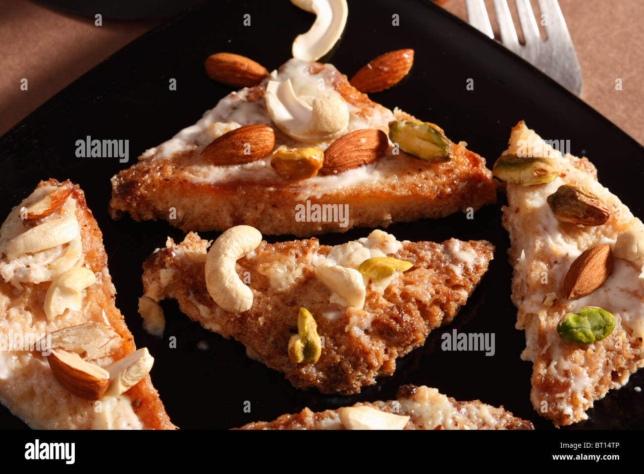 Shahi tukda is prepared with deep fried bread in ghee, garnish with ...