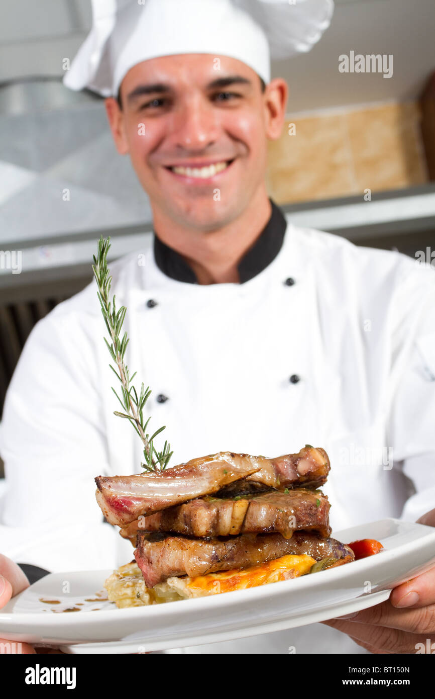 young male chef presenting meat dish Stock Photo - Alamy