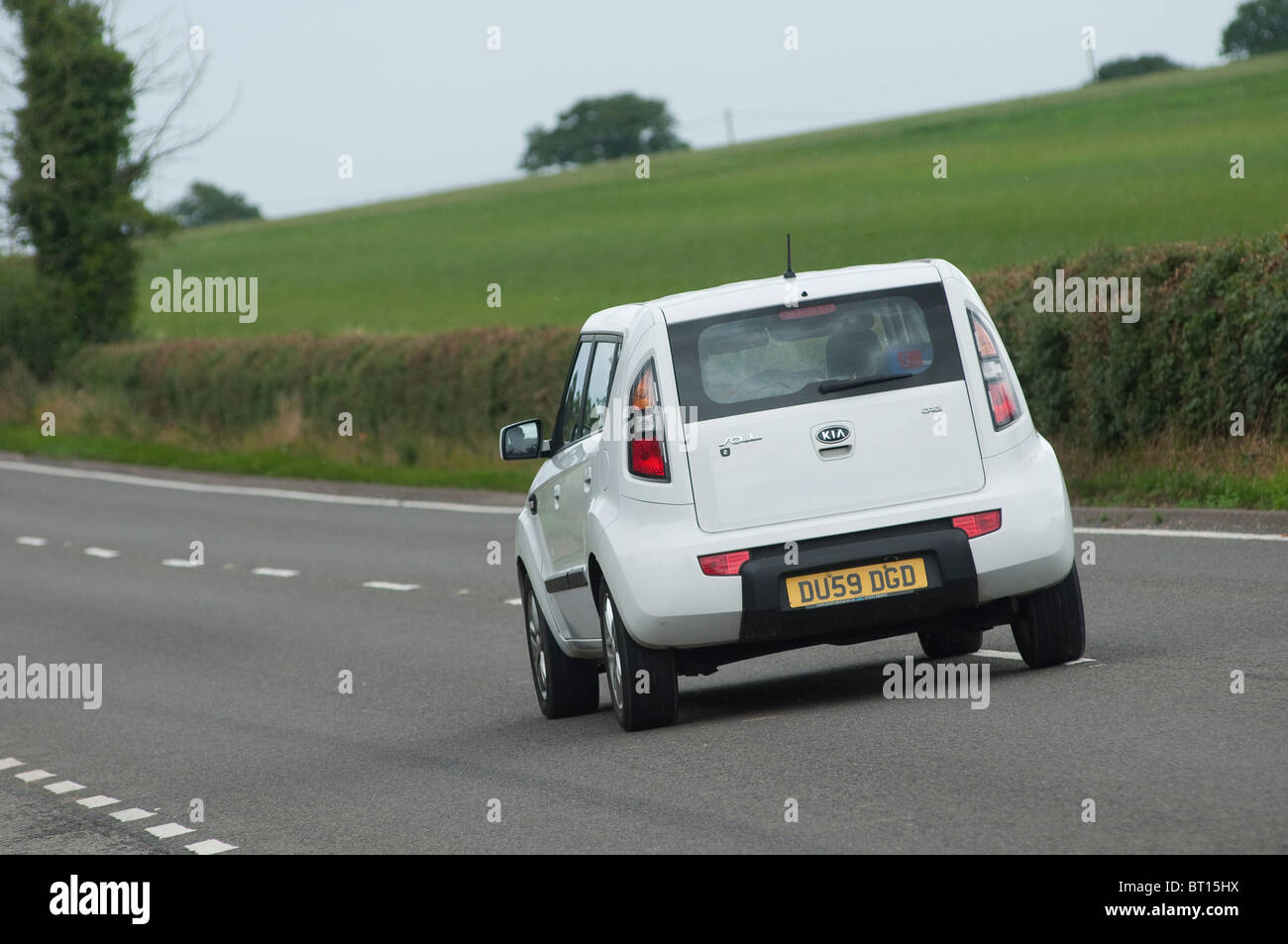 Rear view of a Kia Soul mpv car travelling along a road in the English ...