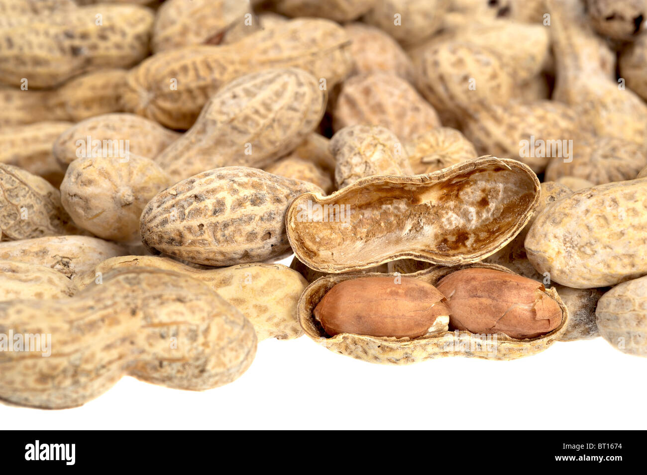 A pile of shelled circus peanuts with one peanut cracked open Stock ...