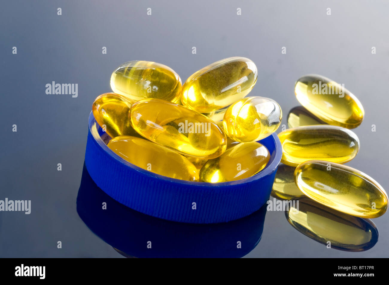 Group of amber translucent gel caps sitting in top lid of prescription ...