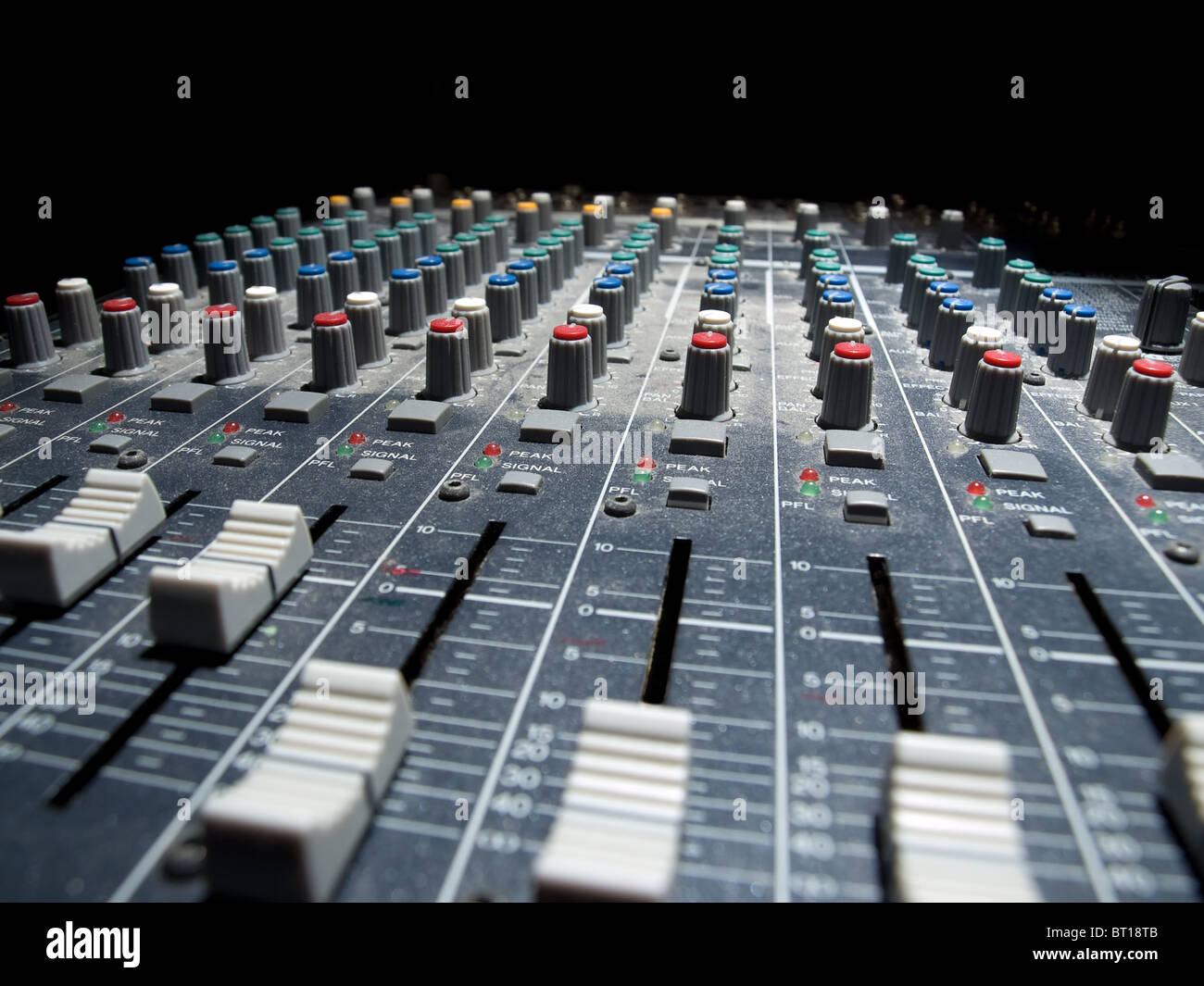 Sound mixer fading into black background, low angle shot with shallow ...