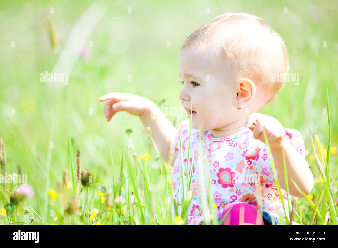 Baby girl spending time outdoor on a summer day Stock Photo - Alamy