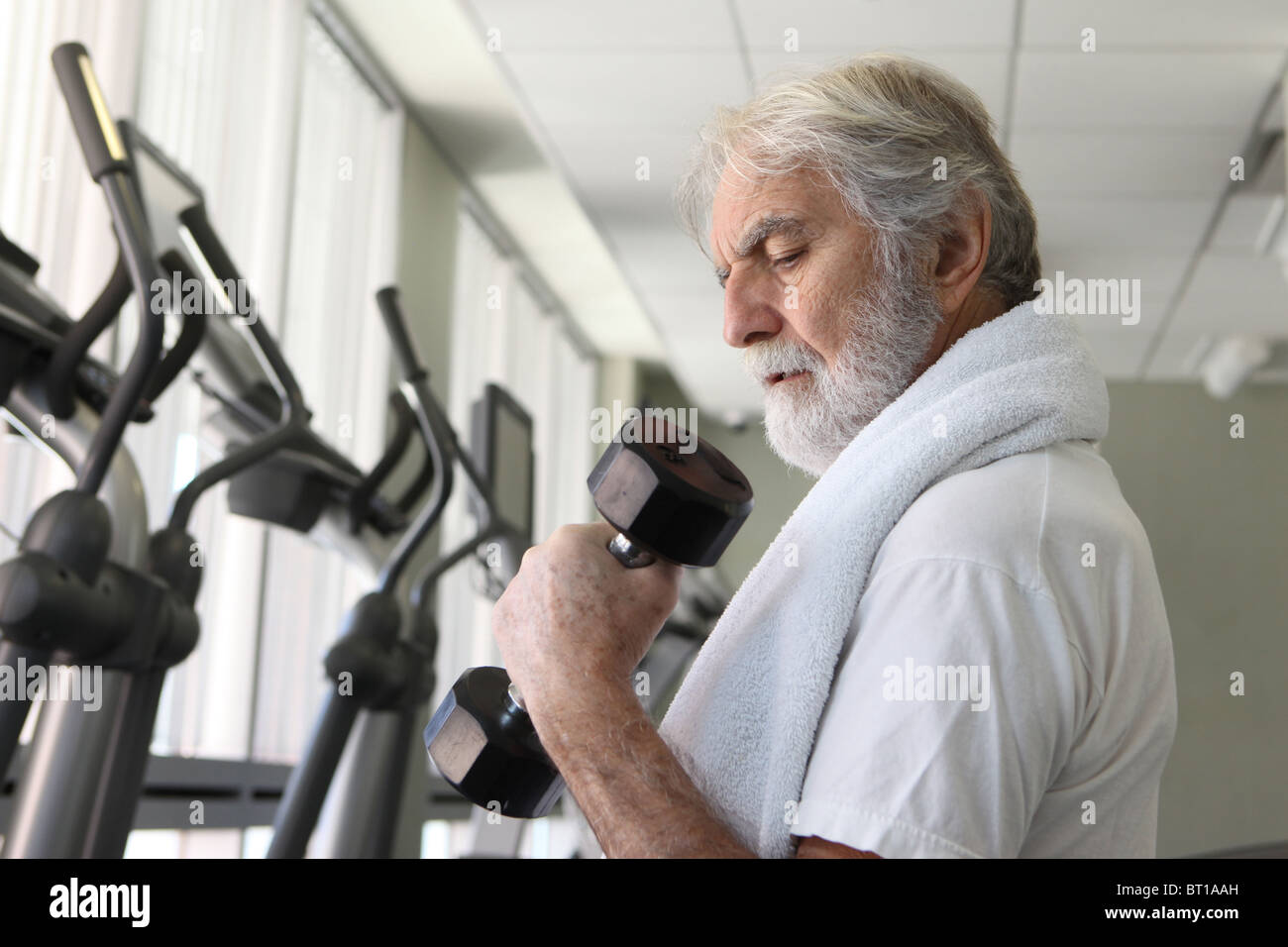 Physically fit and health conscious senior man working out with ...