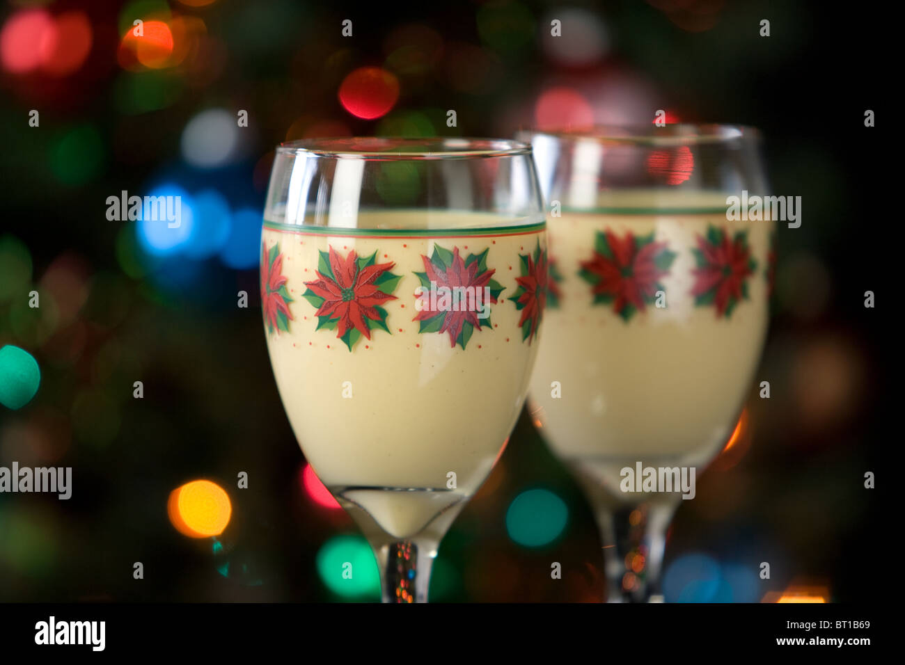 Two glasses of eggnog in front of christmas tree Stock Photo - Alamy