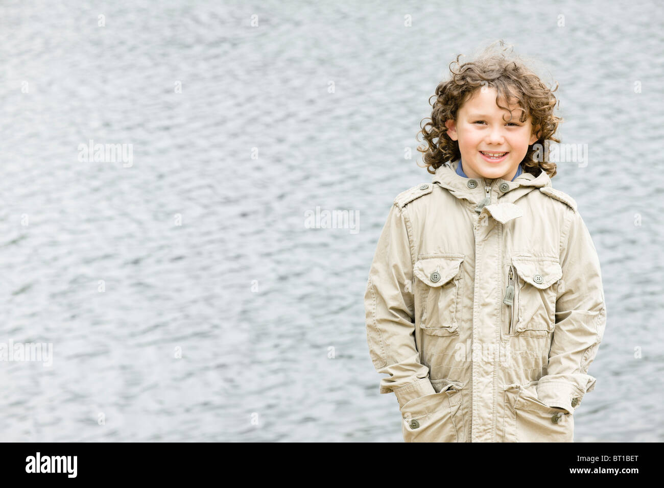 Smiling Caucasian boy with hands in pockets Stock Photo - Alamy