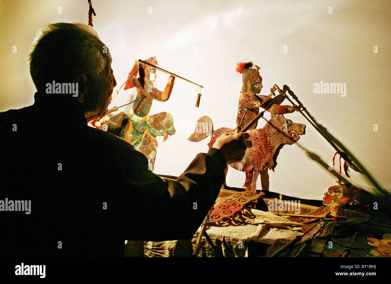 Man playing Chinese shadow Stock Photo - Alamy