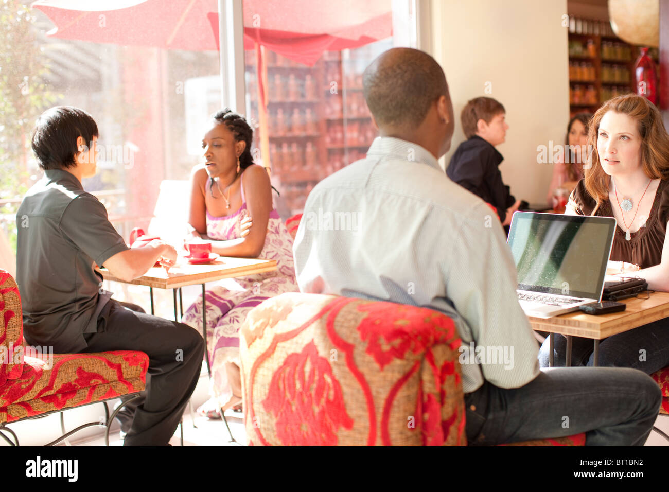 People at tables in cafe Stock Photo - Alamy