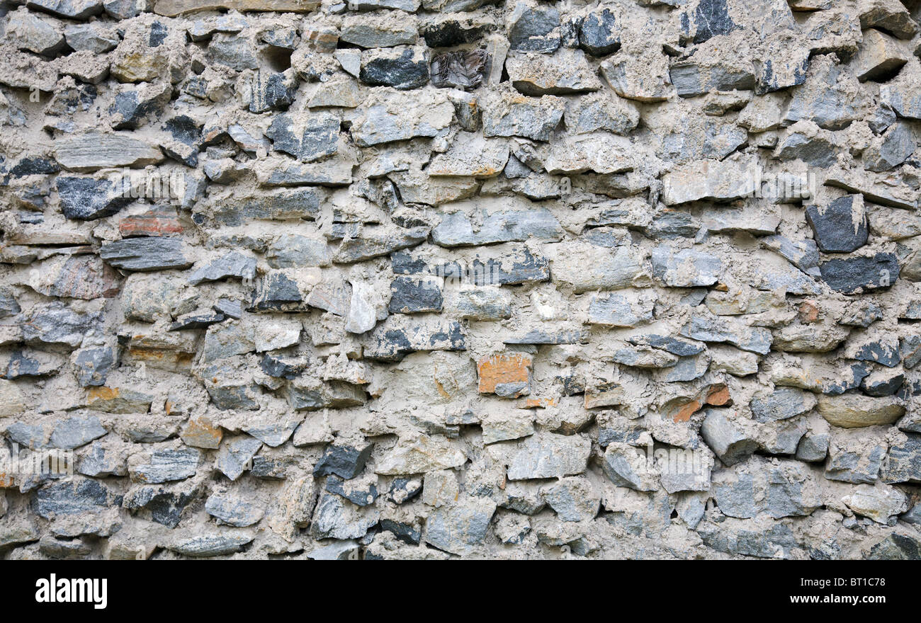 Ancient rough stone wall of a building Stock Photo - Alamy