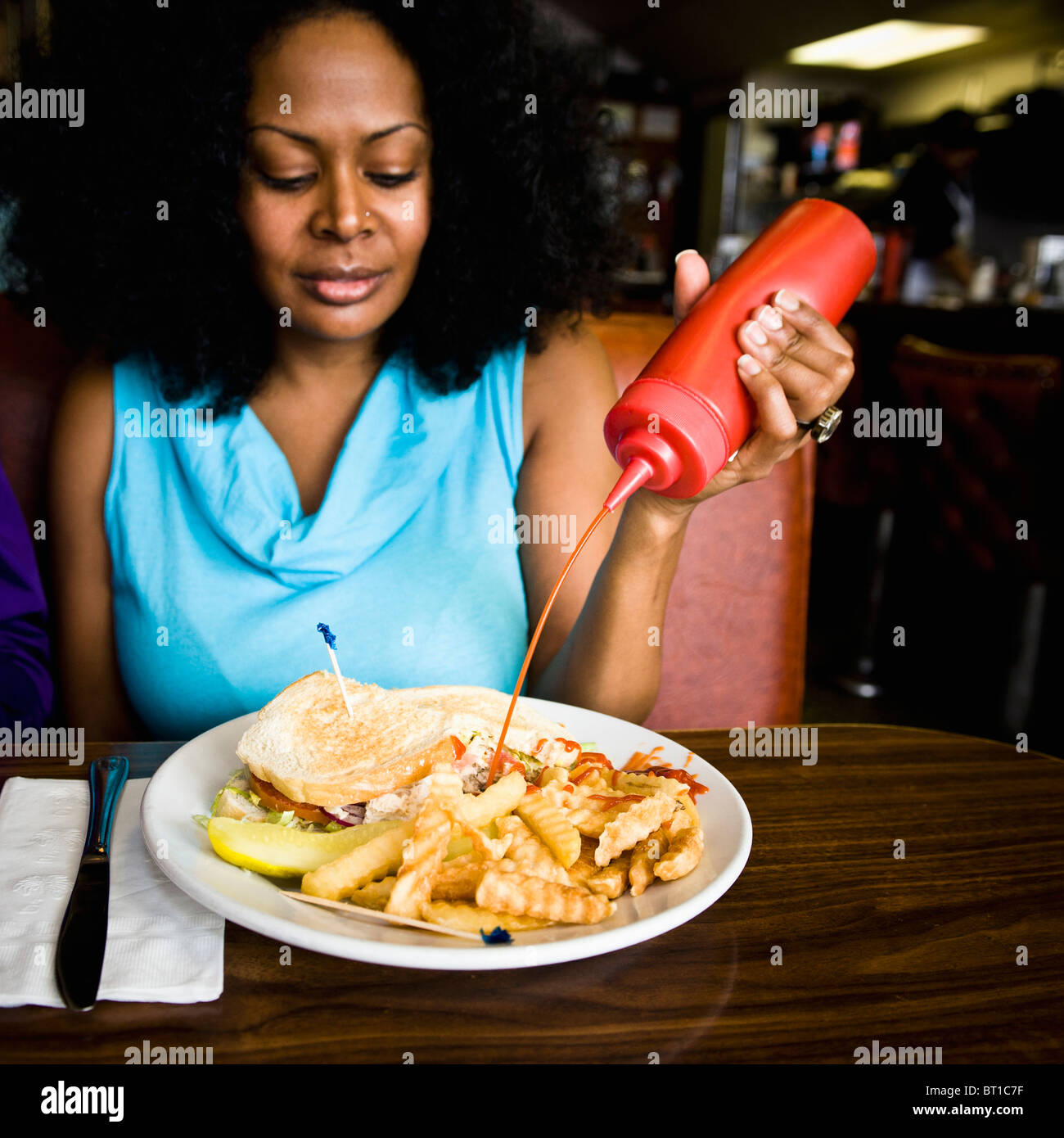 Woman Eating French Fries