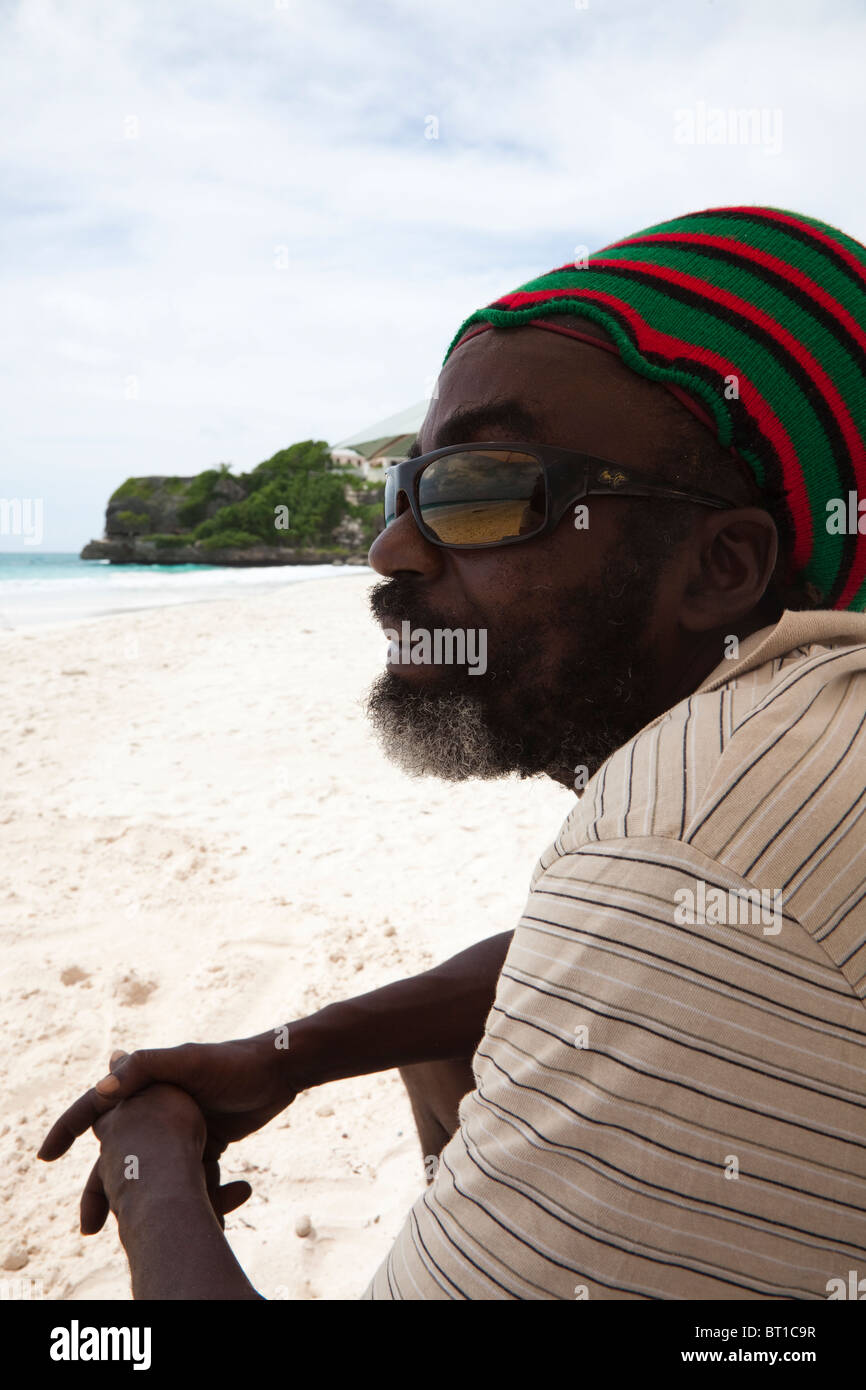 Black man sitting at Crane Bay, Barbados, wearing sunglasses that ...
