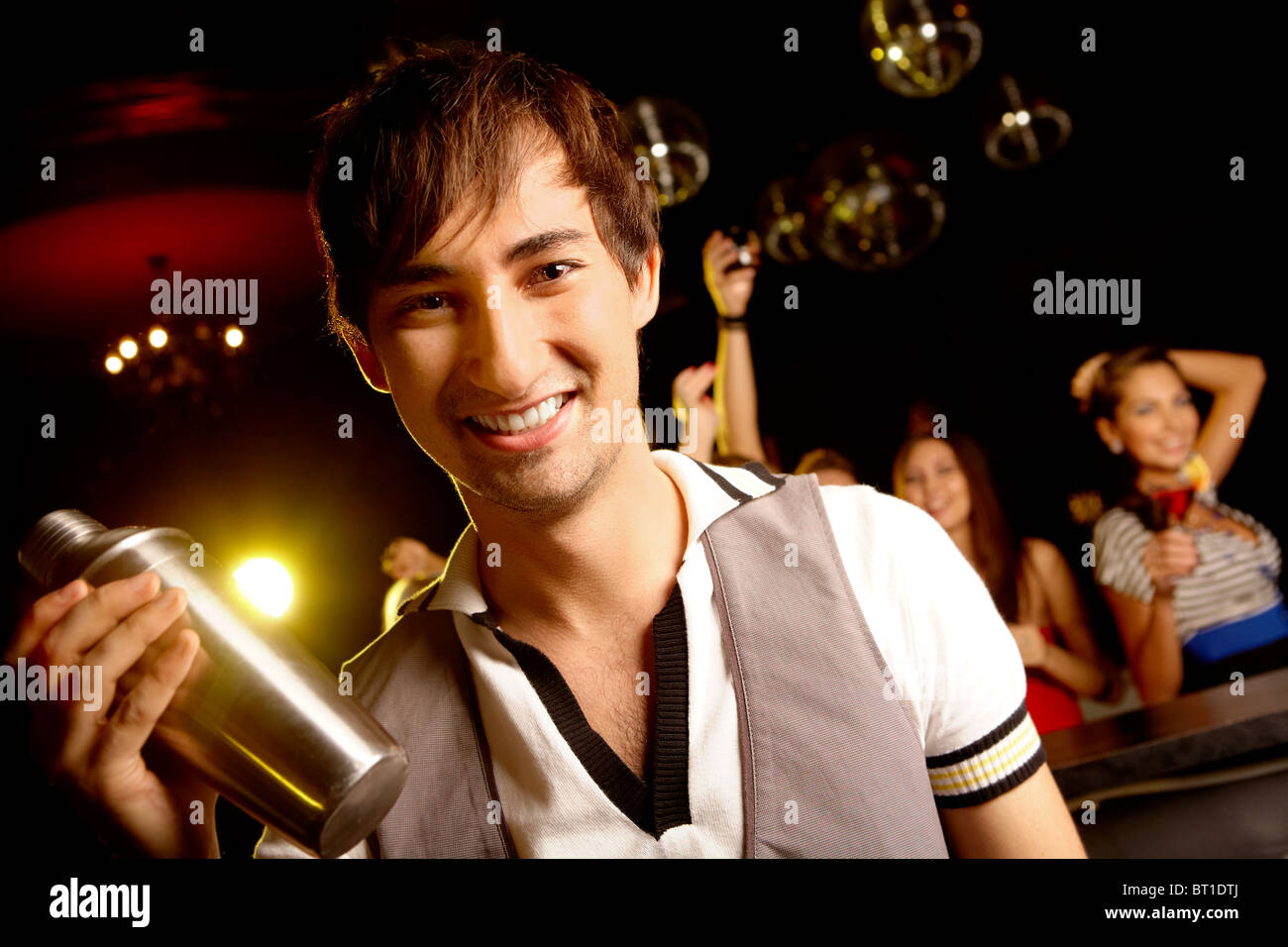 Portrait of smiling male with bottle looking at on background of ...