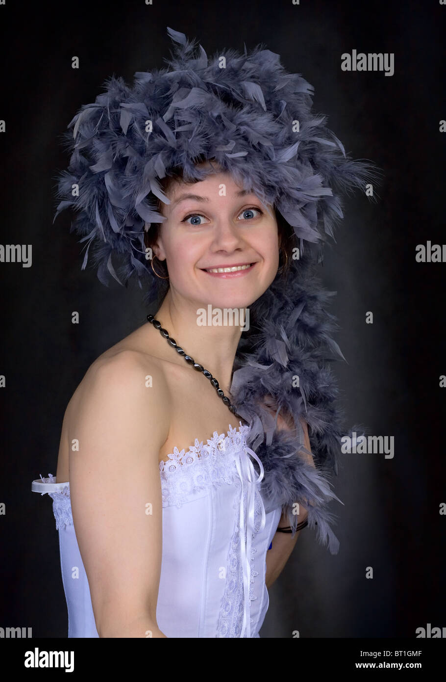 Portrait of the beautiful girl with a boa on a head Stock Photo - Alamy