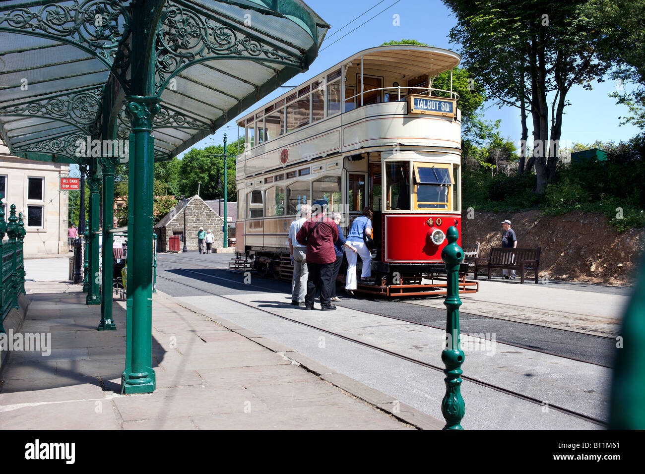 Tourists board a tram in front of the old Derby Assembly Rooms building ...
