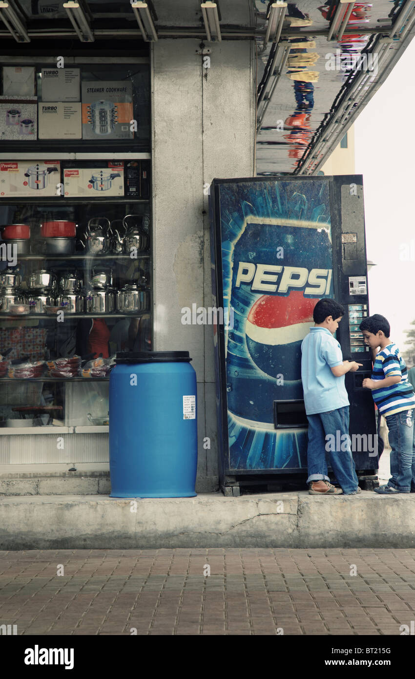 Editorial photo of two boys playing near the Pepsi box Stock Photo - Alamy
